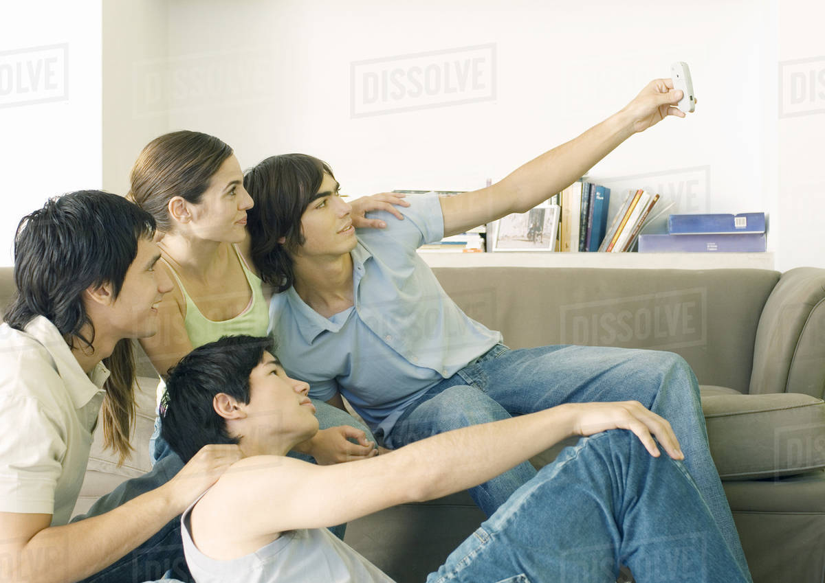 Taking group photo with cell phone - Stock Photo - Dissolve
