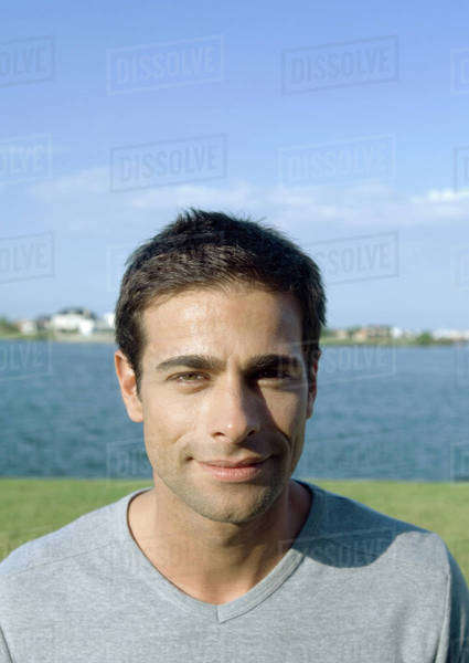 Man with lake in background, portrait - Stock Photo - Dissolve