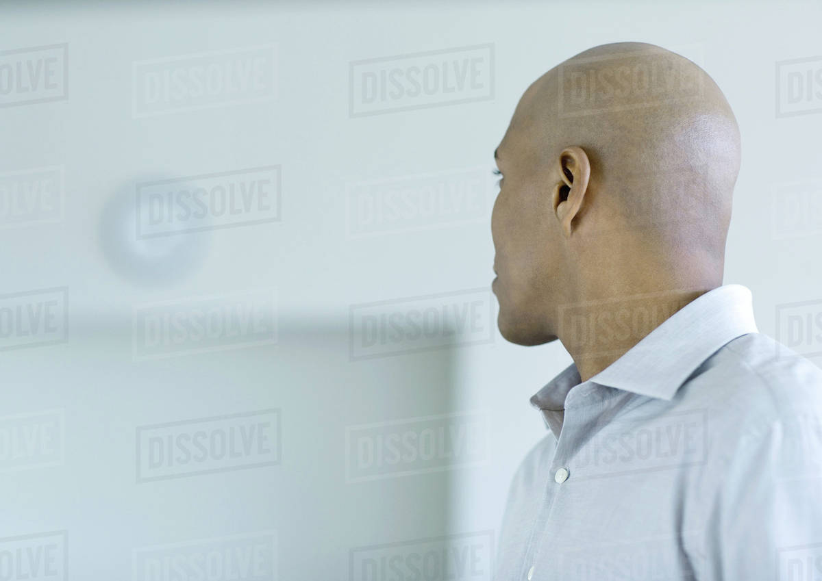 Man looking at clock - Royalty-free Stock Photo | Dissolve