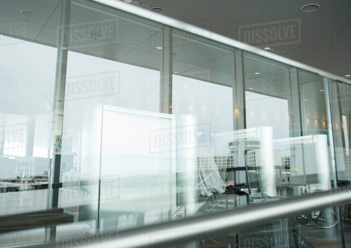 Telephones in airport, seen through glass wall - Royalty-free Stock ...