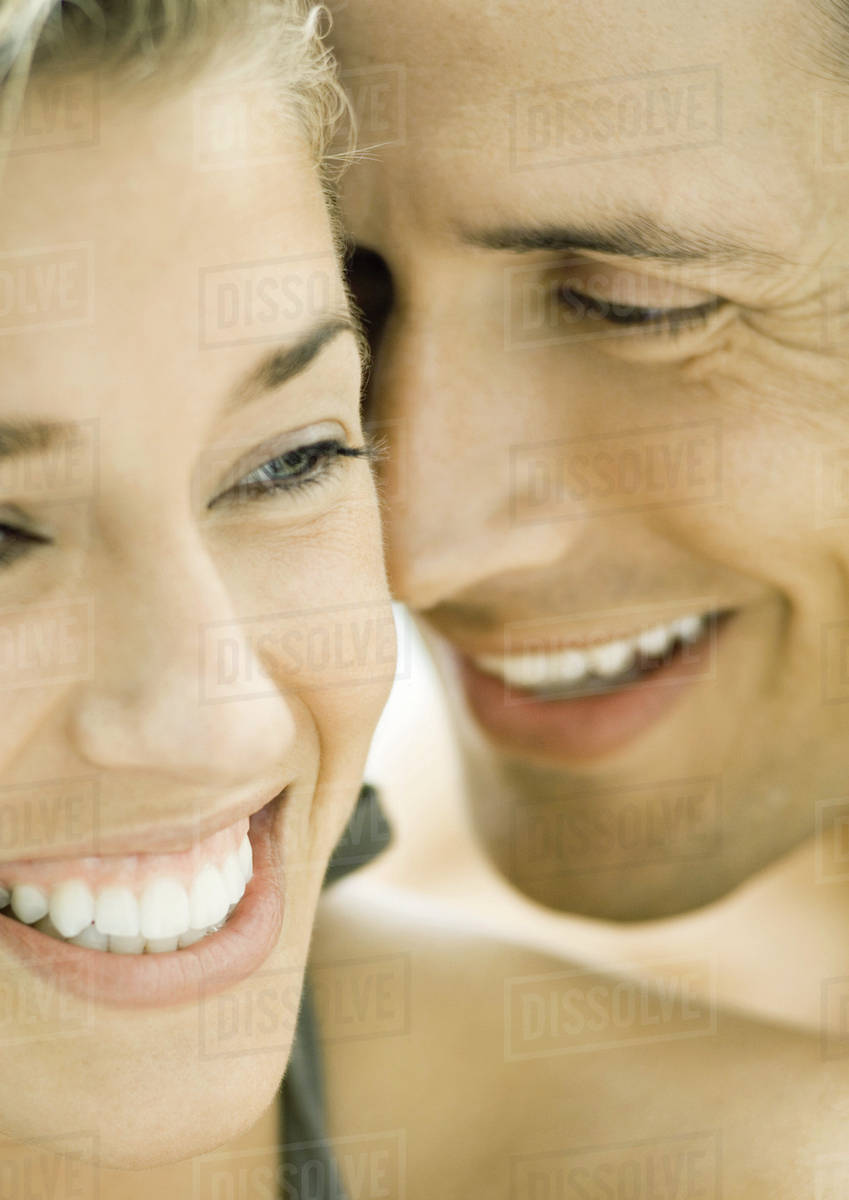 Couple smiling, faces close-together - Royalty-free Stock Photo | Dissolve