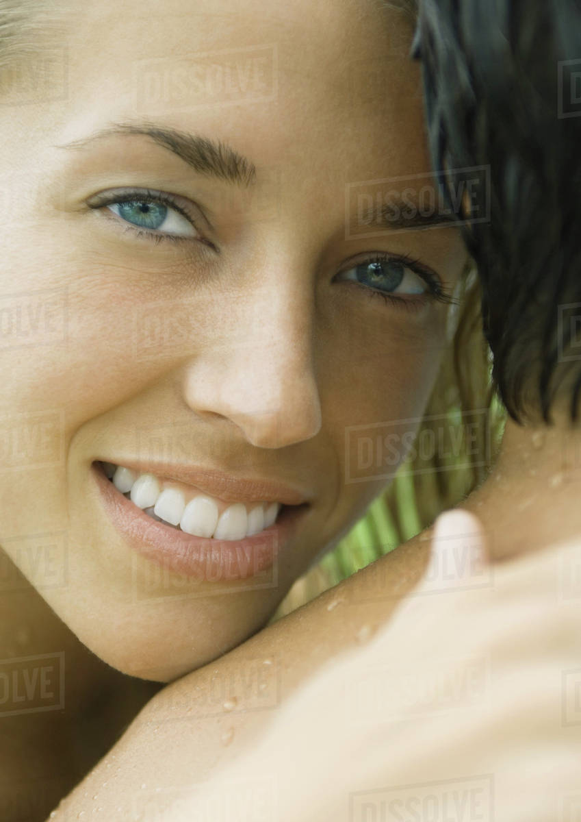 Woman embracing man, smiling at camera - Royalty-free Stock Photo ...