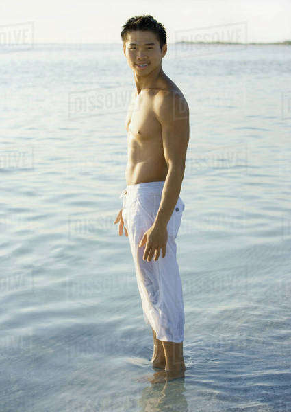 Man standing in sea - Royalty-free Stock Photo | Dissolve