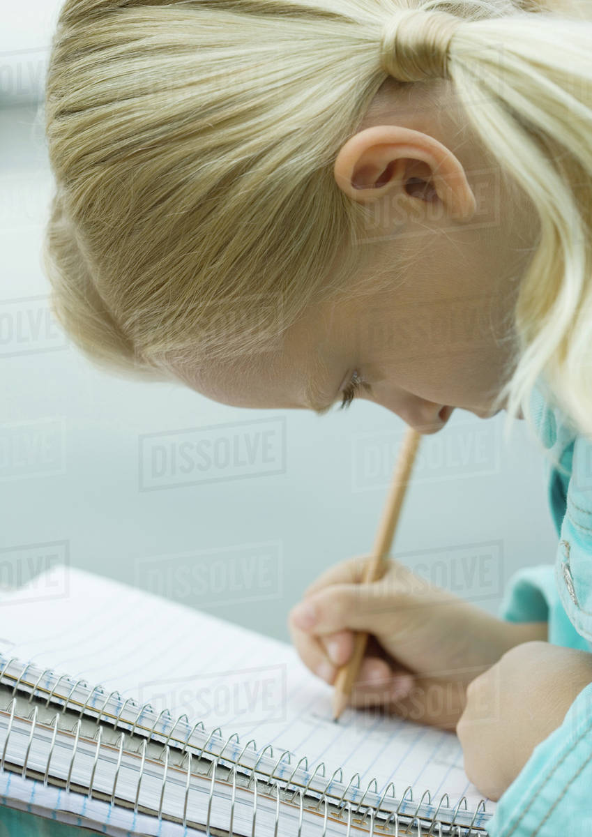 Girl writing in notebook - Stock Photo - Dissolve