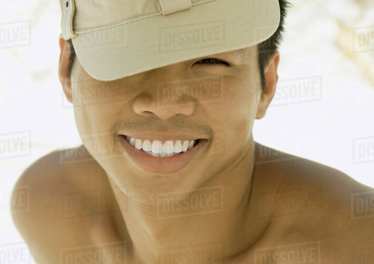 Man wearing cap tilted over eye - Royalty-free Stock Photo | Dissolve