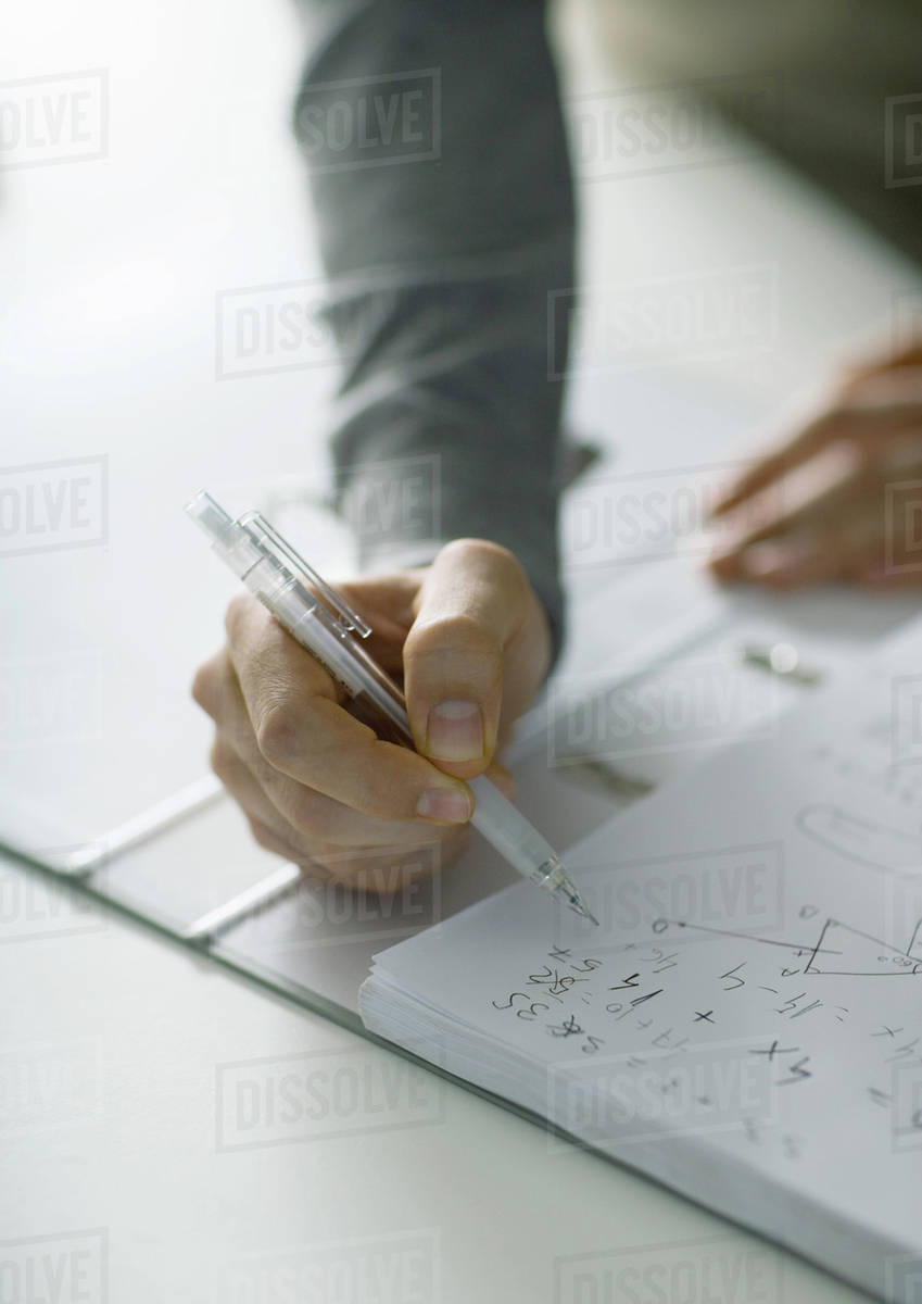 Person's hand posed over notebook with math notes - Royalty-free Stock ...
