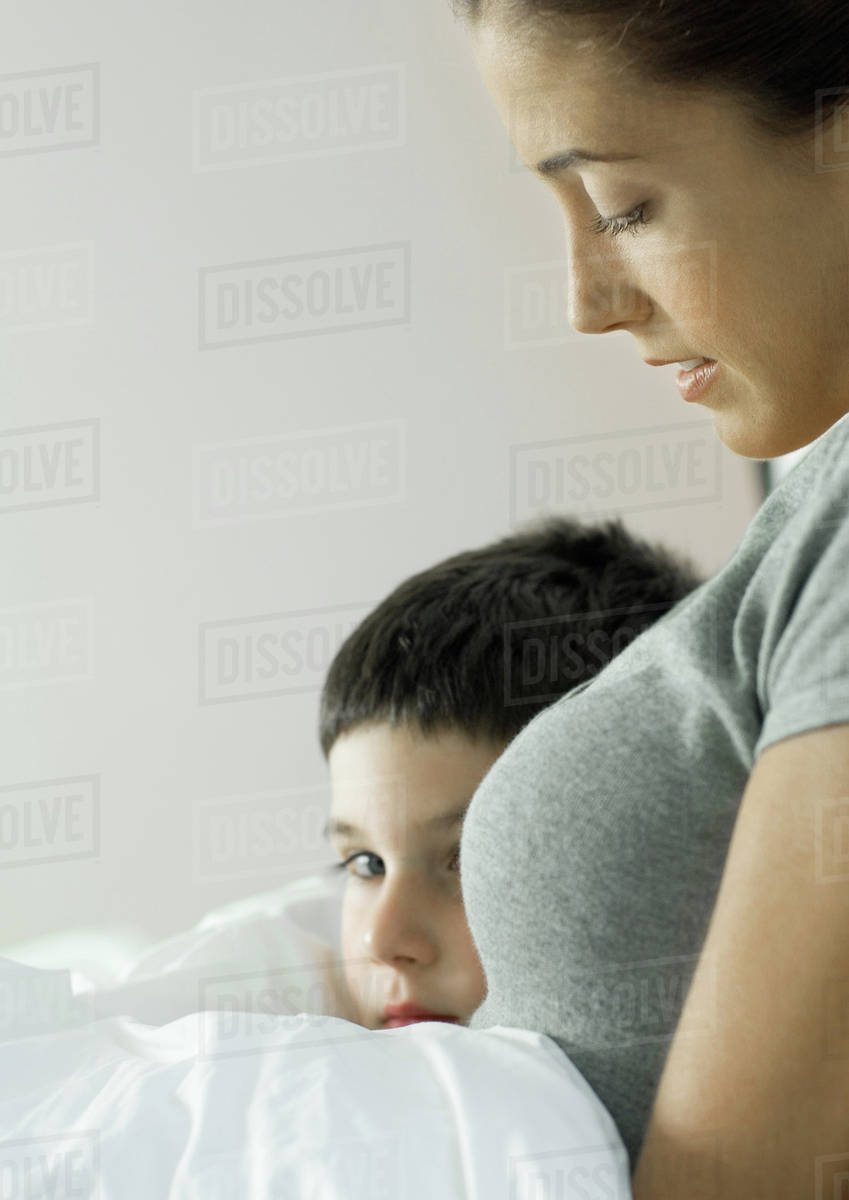 Child leaning against mother - Royalty-free Stock Photo | Dissolve