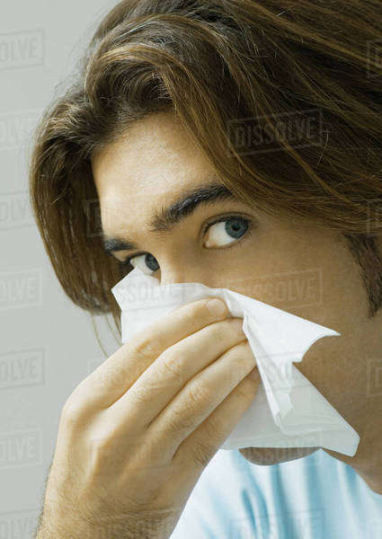 Man wiping nose - Stock Photo - Dissolve