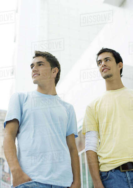 Two teen boys standing, looking out of frame - Royalty-free Stock Photo ...