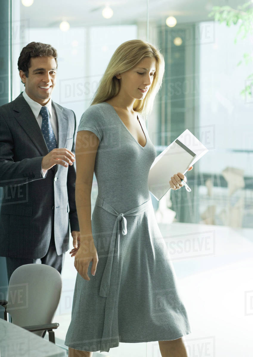 Professional man and woman stepping away from table - Royalty-free ...