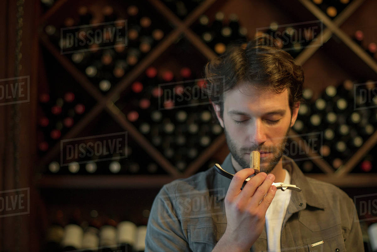 Sommelier sniffing wine cork - Royalty-free Stock Photo | Dissolve
