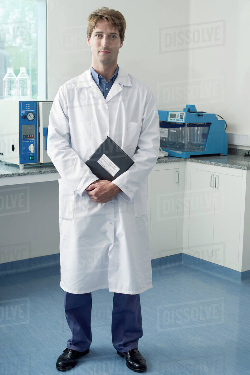 Scientist standing in lab, portrait - Royalty-free Stock Photo | Dissolve