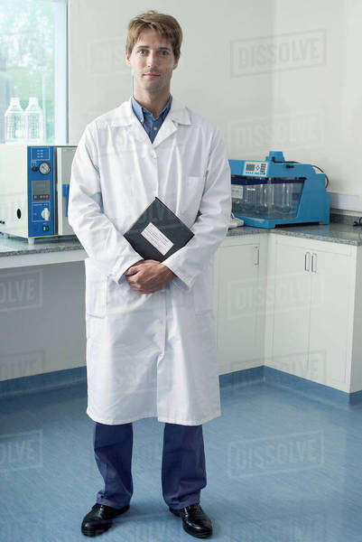 Scientist standing in lab, portrait - Royalty-free Stock Photo | Dissolve