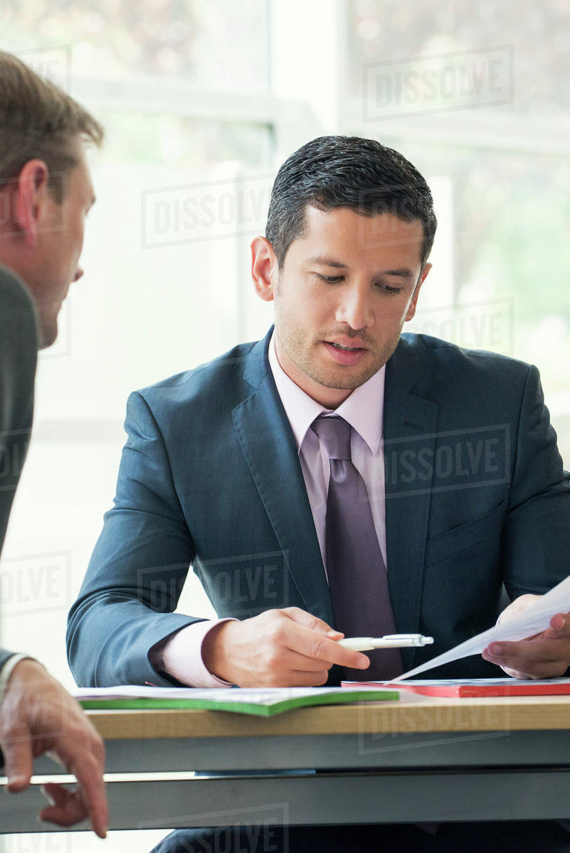 Businessman discussing contract with client - Royalty-free Stock Photo ...