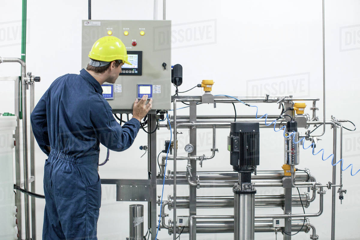 Worker operating industrial equipment - Royalty-free Stock Photo | Dissolve