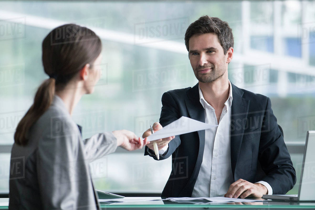 Businessman handing document to client - Royalty-free Stock Photo ...