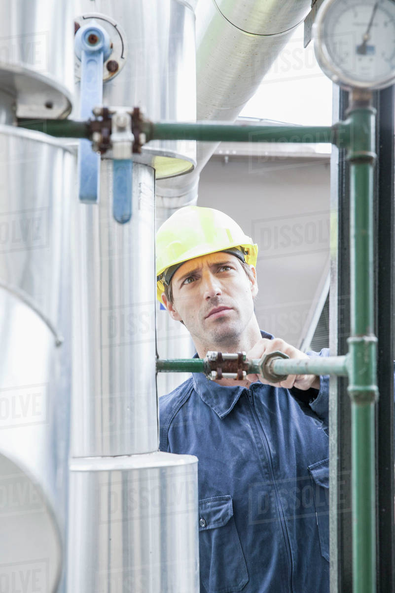 Skilled worker inspecting industial equipment - Royalty-free Stock ...