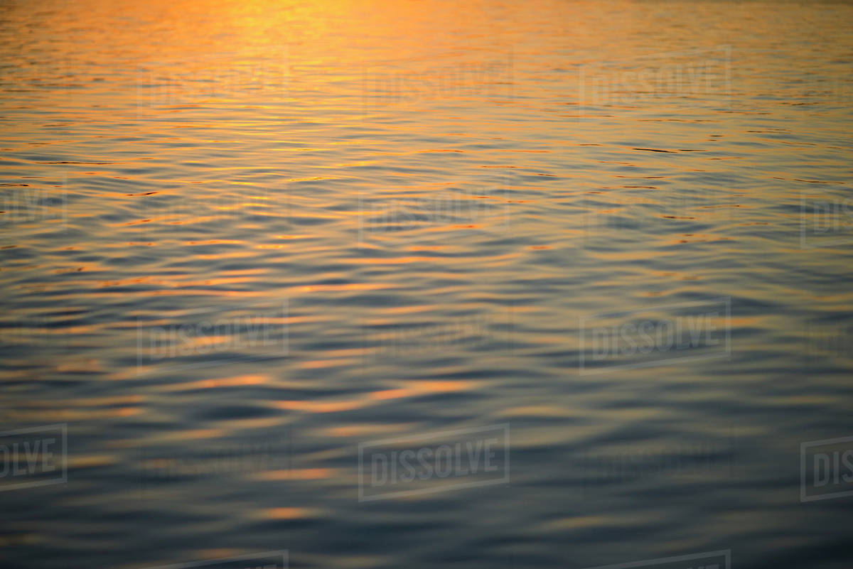 Sunset reflected on surface of water - Royalty-free Stock Photo | Dissolve