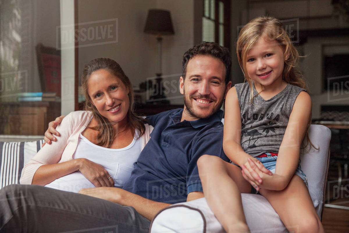 Family at home together, portrait - Stock Photo - Dissolve