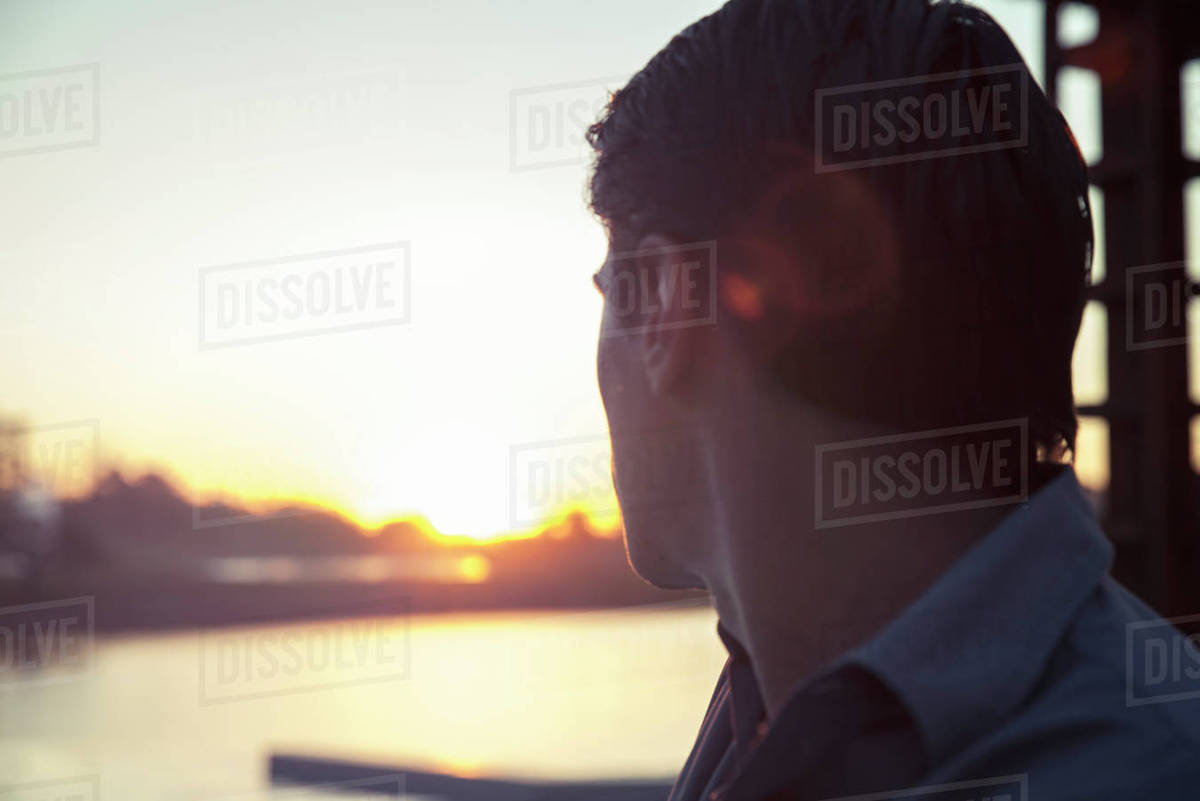Man looking at sunset - Royalty-free Stock Photo | Dissolve