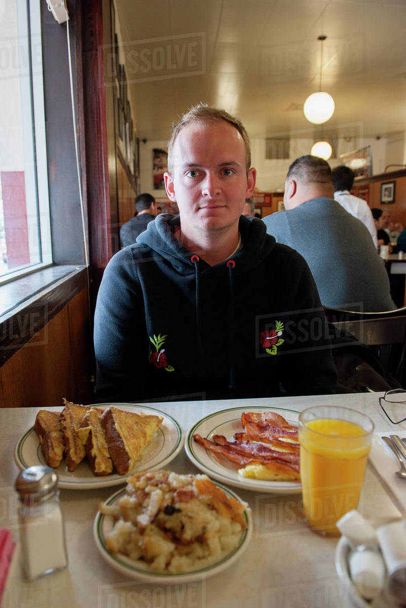 Man eating breakfast in diner - Royalty-free Stock Photo | Dissolve