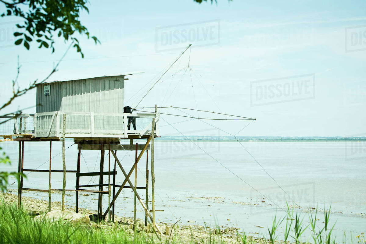Fishing hut on stilts near water's edge - Royalty-free Stock Photo ...