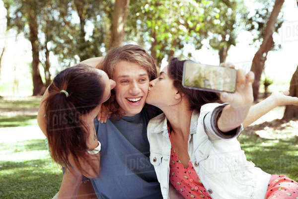 Friends taking selfie together at park - Royalty-free Stock Photo ...