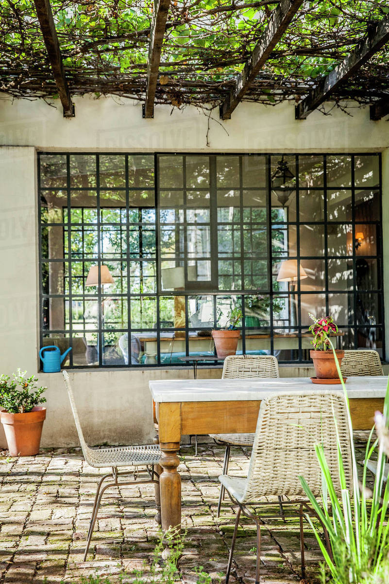 Veranda sheltered beneath trellis green with lush foliage - Royalty ...