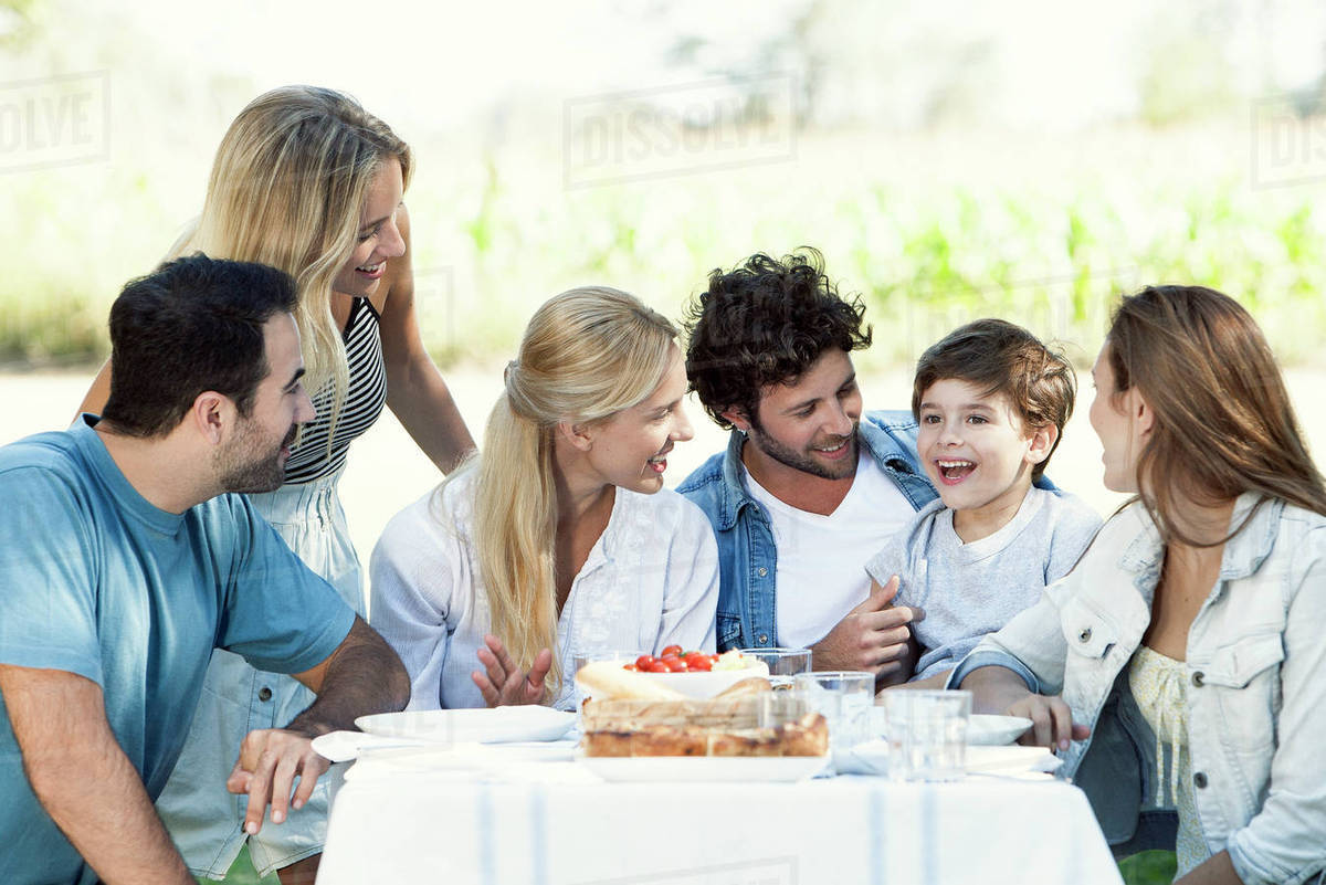 Family and friends spending time together outdoors - Royalty-free Stock ...