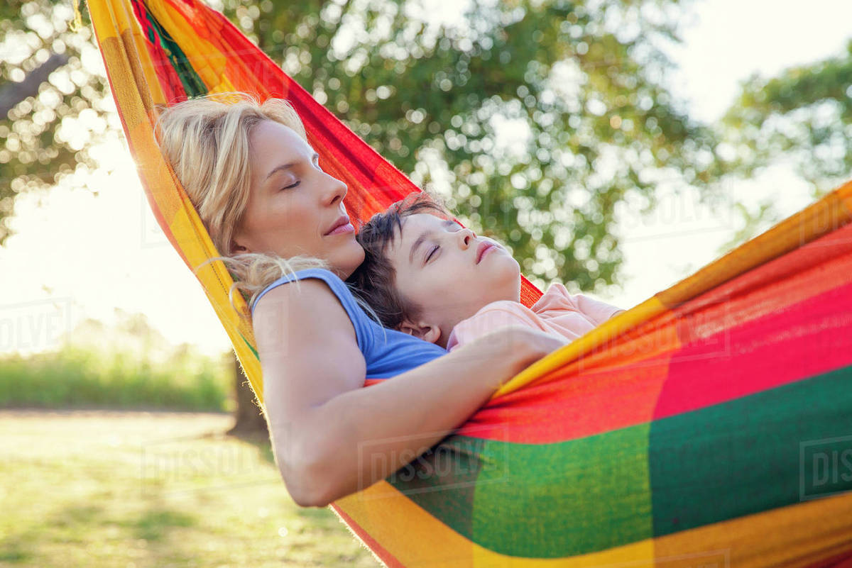 Mother and son napping together in hammock - Stock Photo - Dissolve
