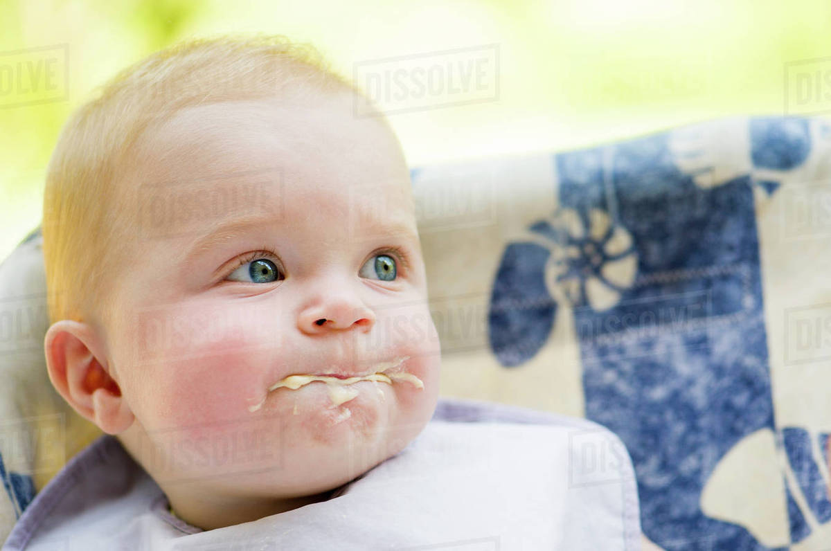 Messy baby eating, portrait - Royalty-free Stock Photo | Dissolve