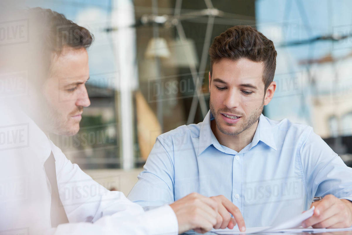 Insurance agent explaining contact to client - Stock Photo - Dissolve