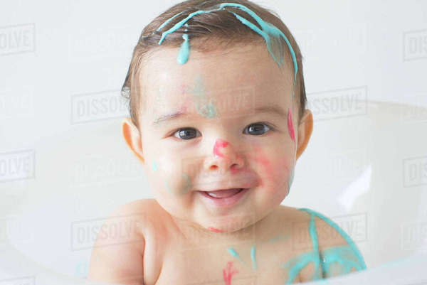 Baby splattered in colorful soap at bathtime - Stock Photo - Dissolve