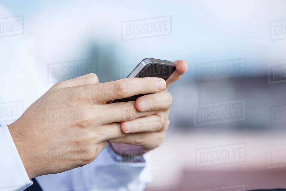 Using smartphone, close-up - Royalty-free Stock Photo | Dissolve