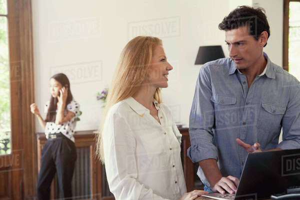 Colleagues talking together in office - Stock Photo - Dissolve