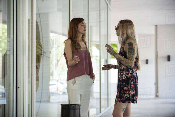 Women taking a cigarette break together - Stock Photo - Dissolve