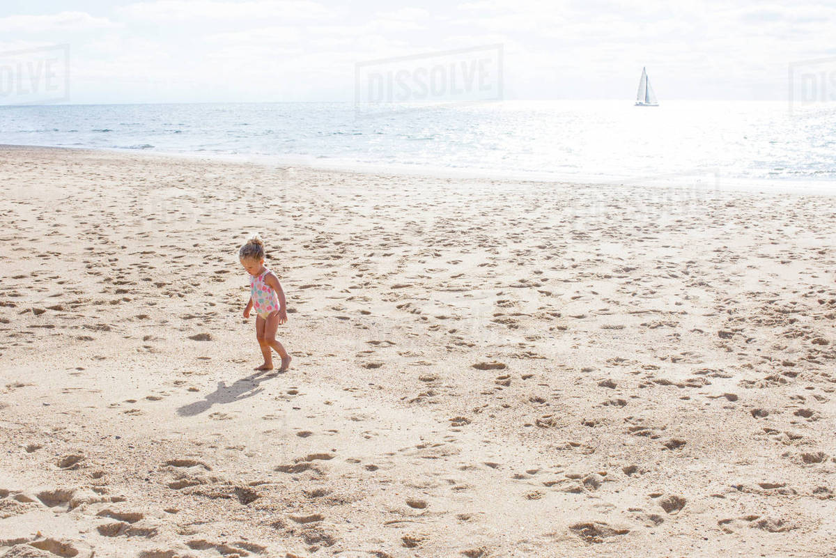 Little girl walking on beach - Royalty-free Stock Photo | Dissolve