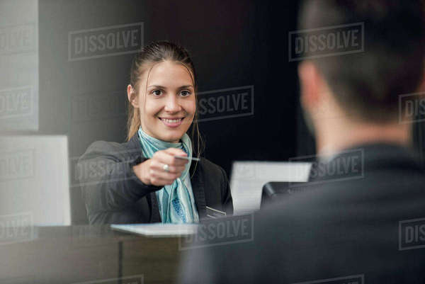 Bank teller helping customer - Stock Photo - Dissolve