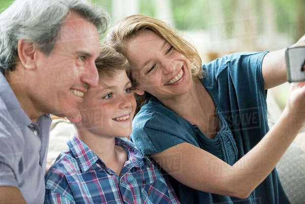 Family posing for selfie together - Royalty-free Stock Photo | Dissolve