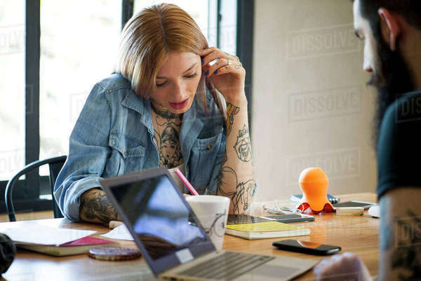 College students studying at shared table - Stock Photo - Dissolve