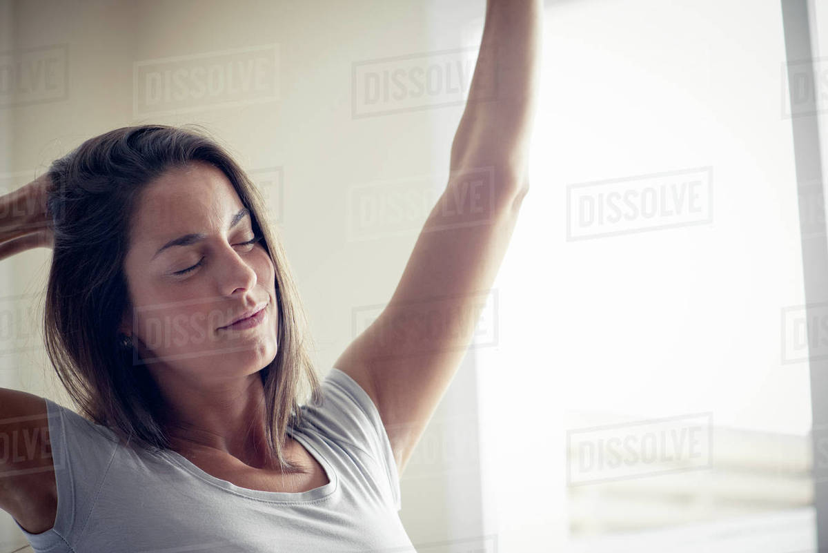 Young woman waking up in morning - Royalty-free Stock Photo | Dissolve