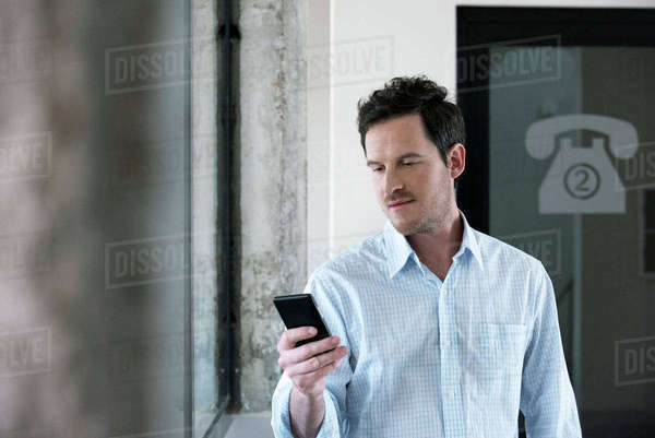 Man using smart phone - Royalty-free Stock Photo | Dissolve