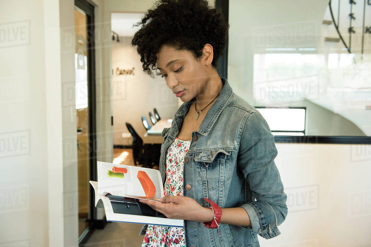 Woman flipping through book - Royalty-free Stock Photo | Dissolve