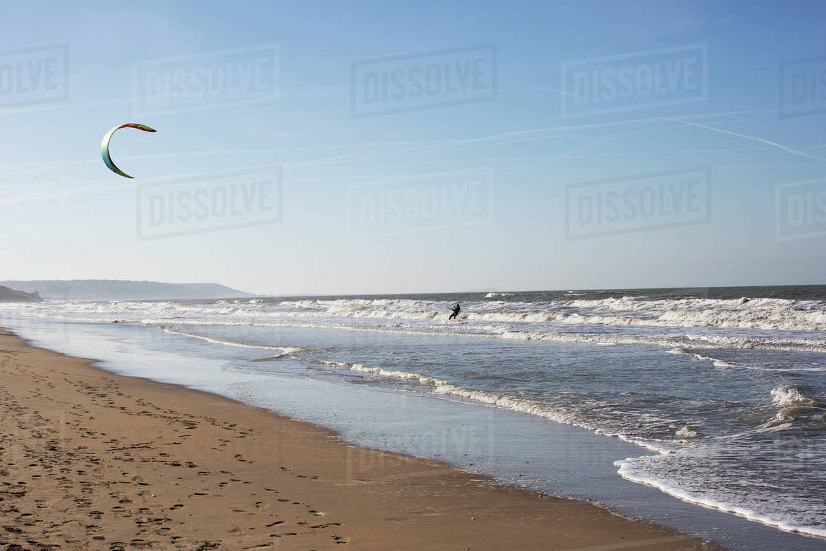 Man paragliding over ocean - Royalty-free Stock Photo | Dissolve