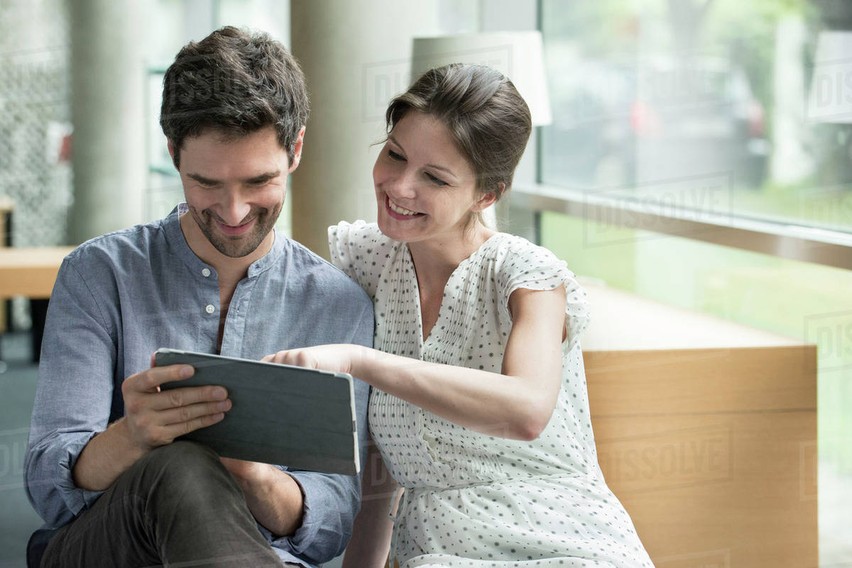 Couple using digital tablet together at home - Royalty-free Stock Photo ...