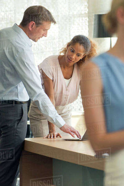 Salesman demonstrating laptop computer for customer - Royalty-free ...