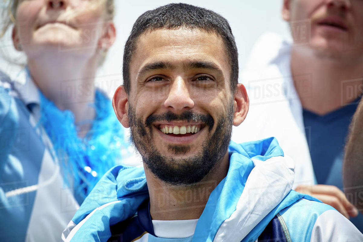Football fan smiling, portrait - Stock Photo - Dissolve