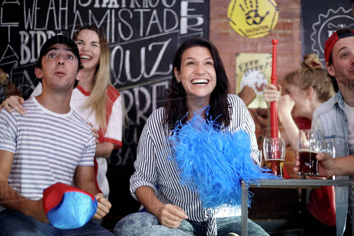 Sports enthusiasts watching match in bar - Royalty-free Stock Photo ...