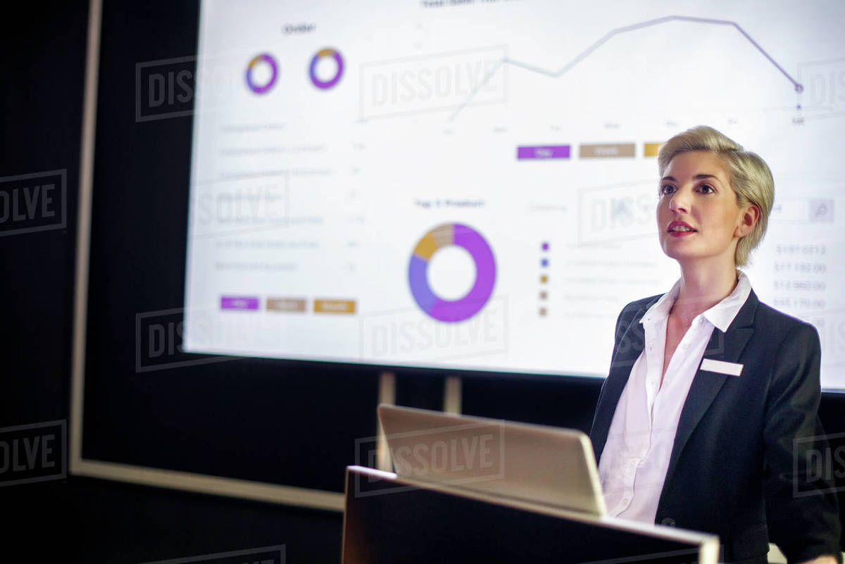 Woman giving presentation - Stock Photo - Dissolve