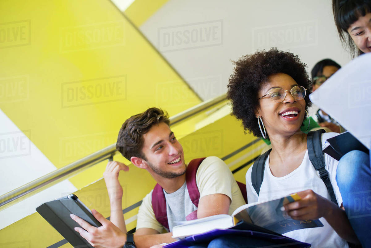 College students laughing while studying between classes - Royalty-free ...
